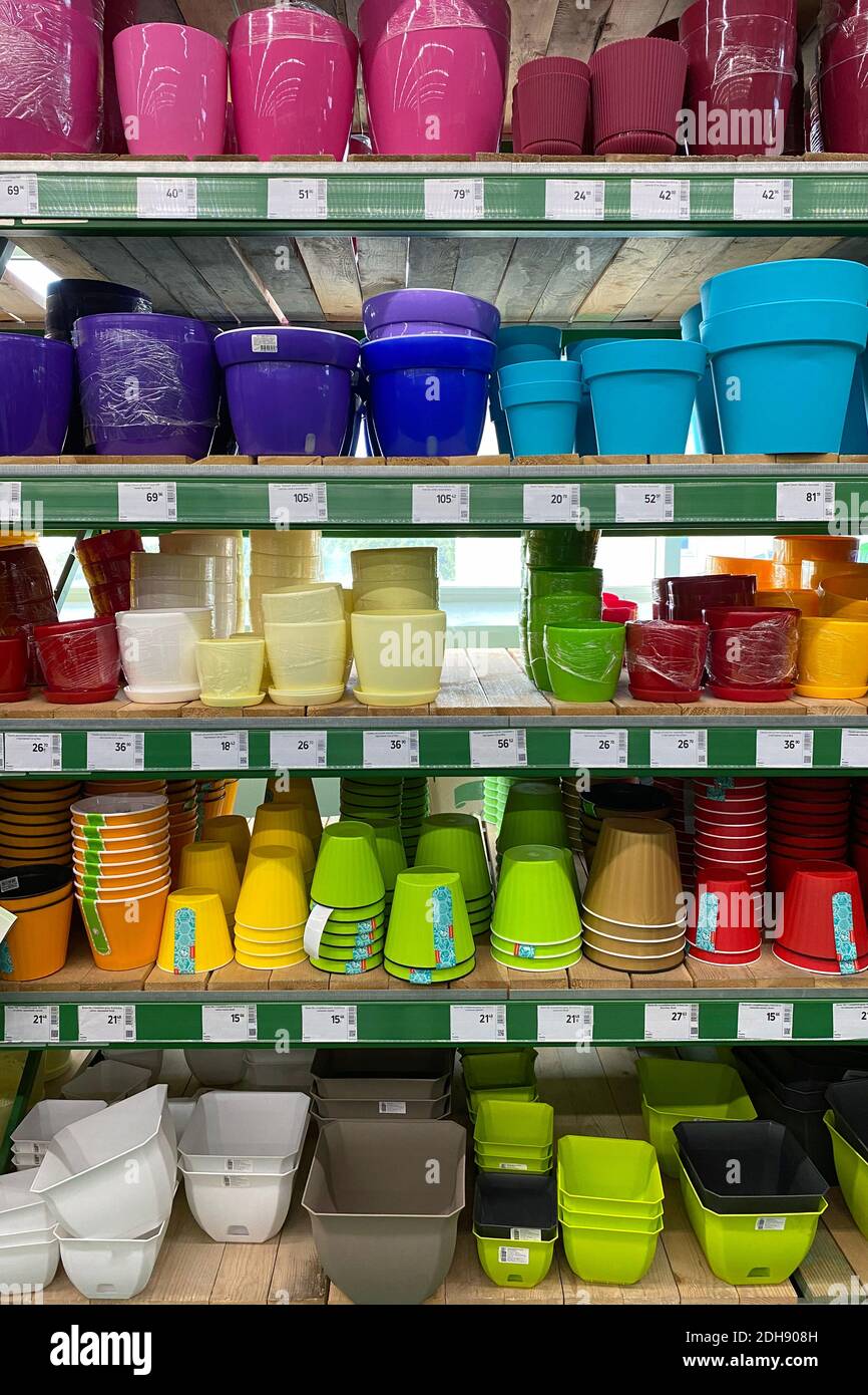 Variety of colorful flower pots are sold at the store. Rows of ...