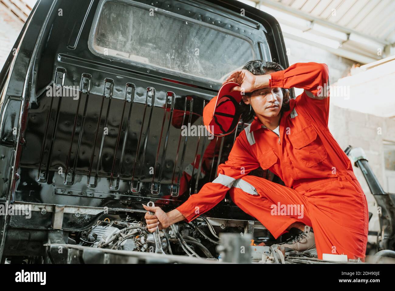 portrait of young asian man repairing a broken car engine part Stock ...