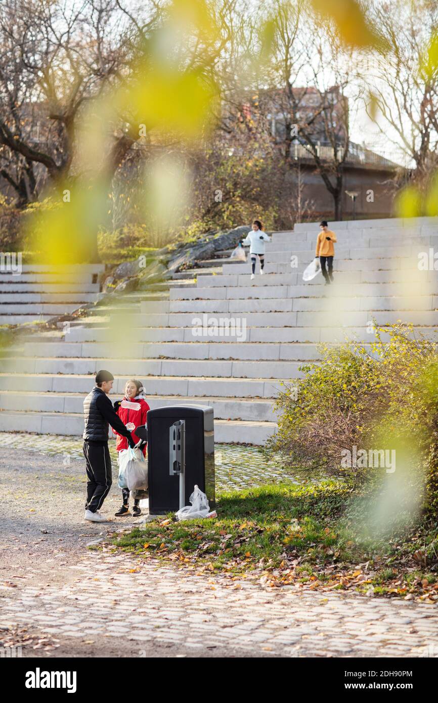 People throwing garbage in waste hi-res stock photography and images ...