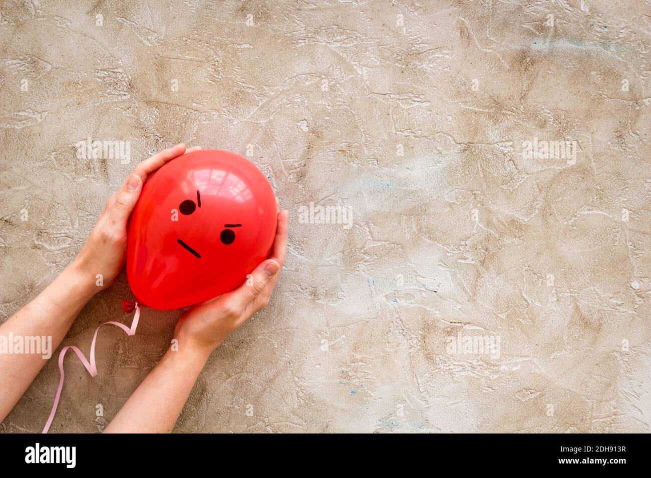 Anger emotion face on balloon - madness mood background. Top view, copy ...