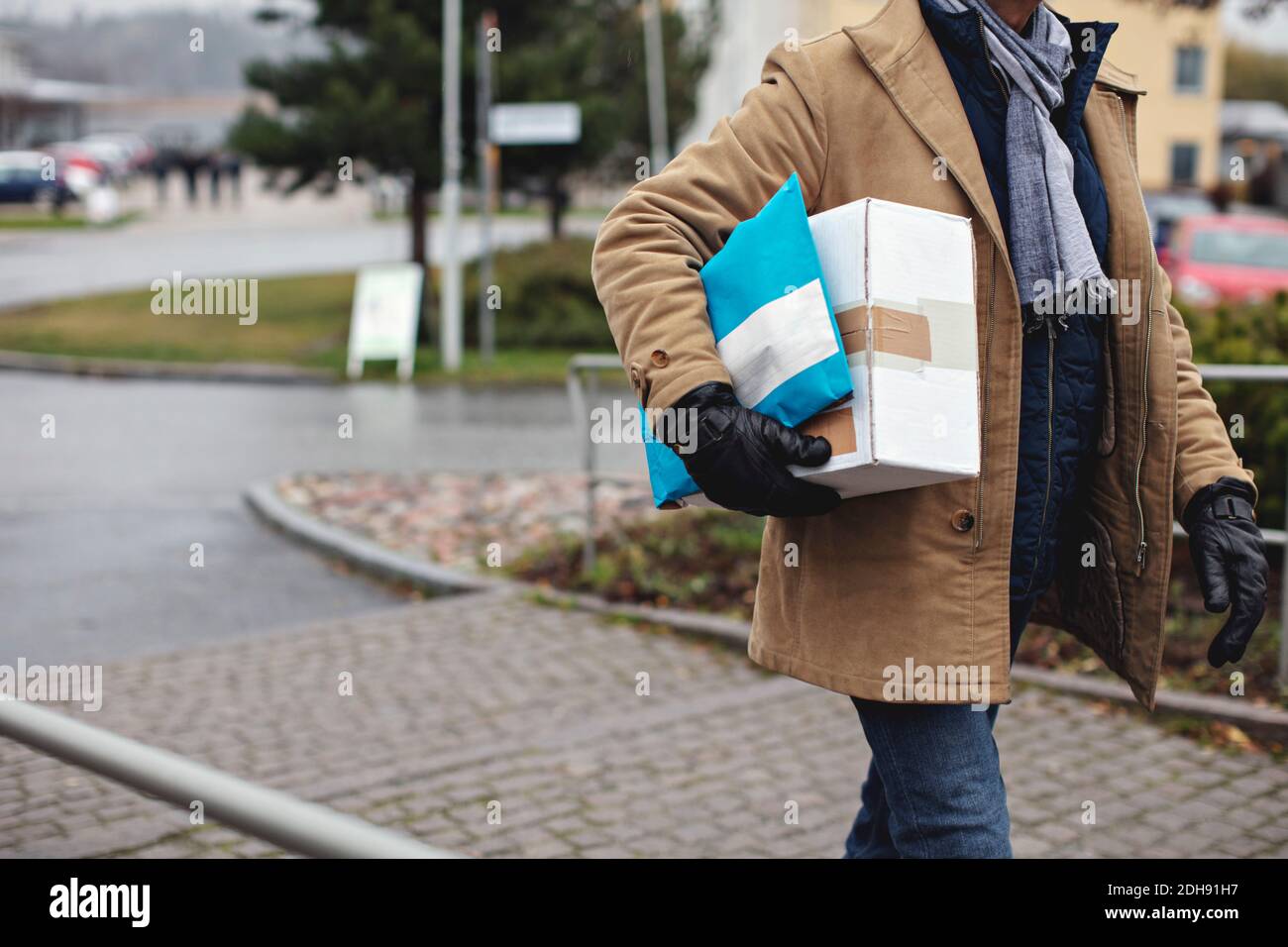 Senior man holding package hi-res stock photography and images - Alamy