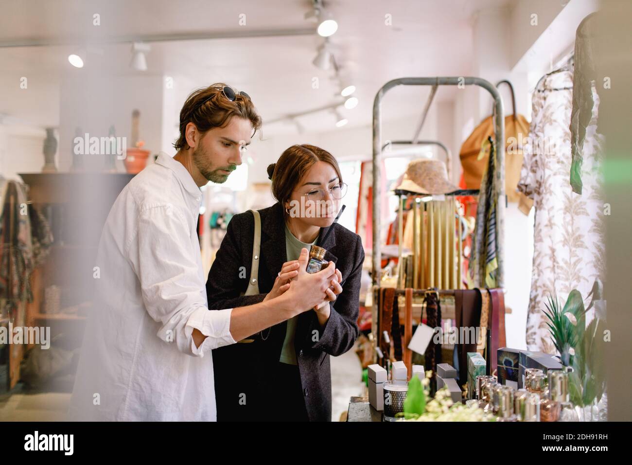 Young couple smelling perfume at fashion store Stock Photo - Alamy