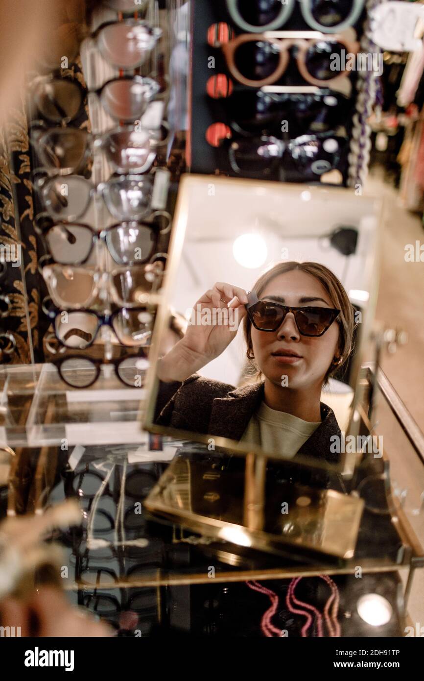 Trying on glasses in mirror hi-res stock photography and images - Alamy