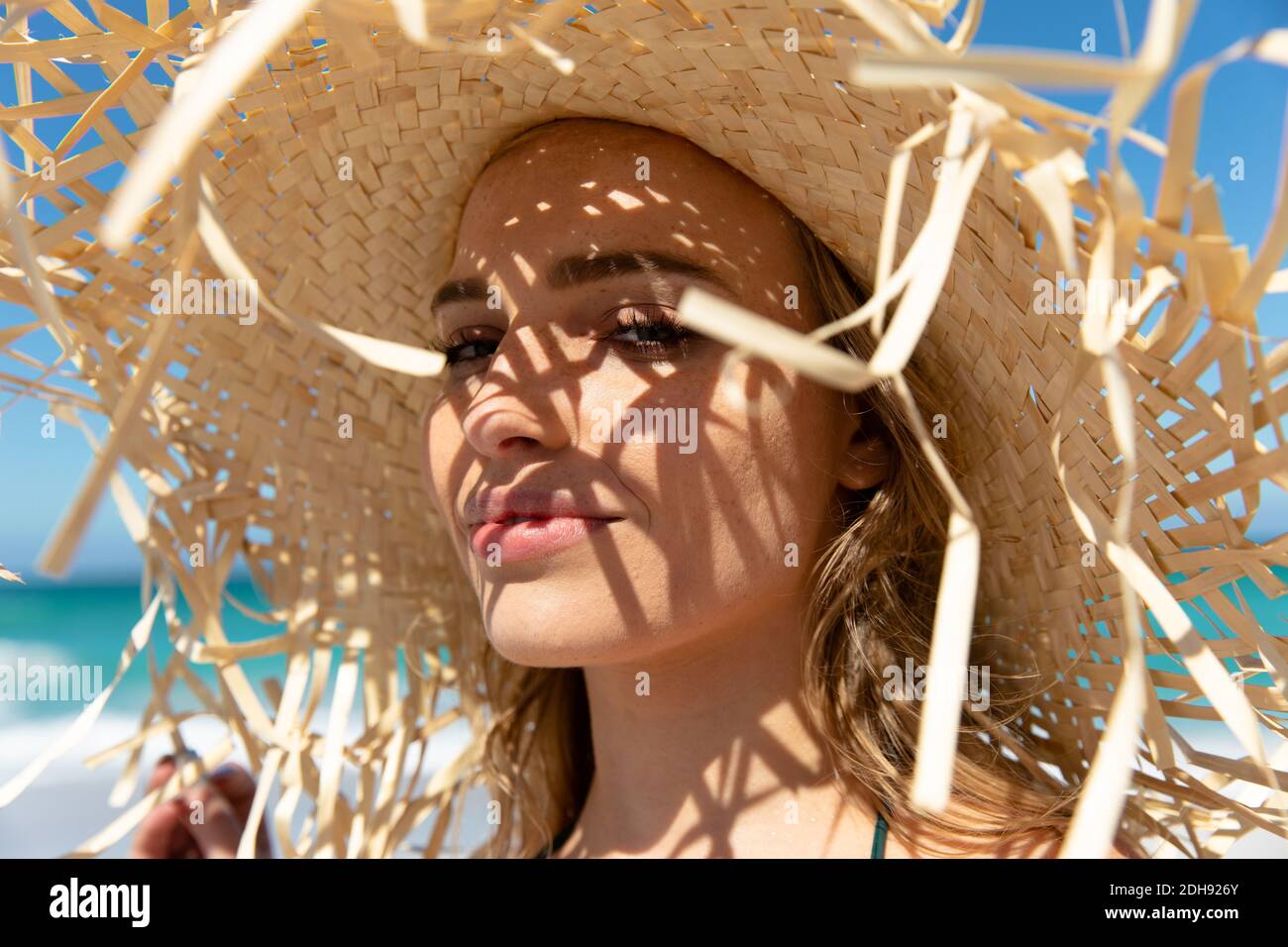 Young woman with straw hat at the beach Stock Photo - Alamy