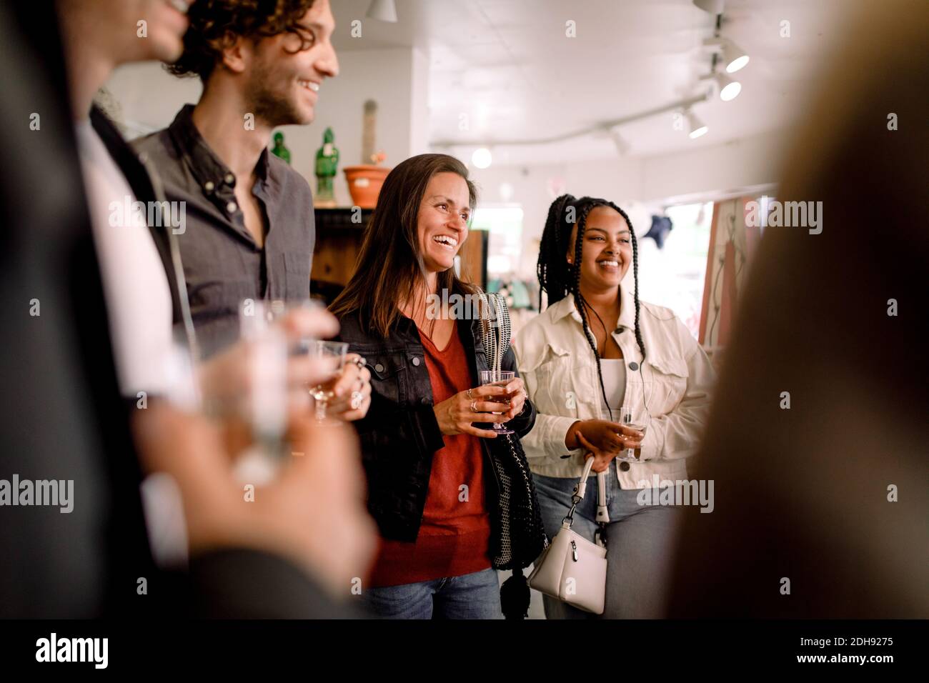 Smiling customers at fashion store Stock Photo - Alamy
