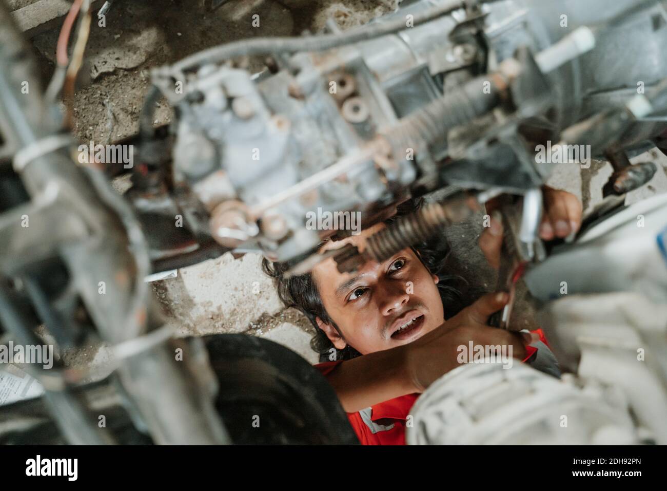portrait of young asian man repairing a broken car engine part Stock ...