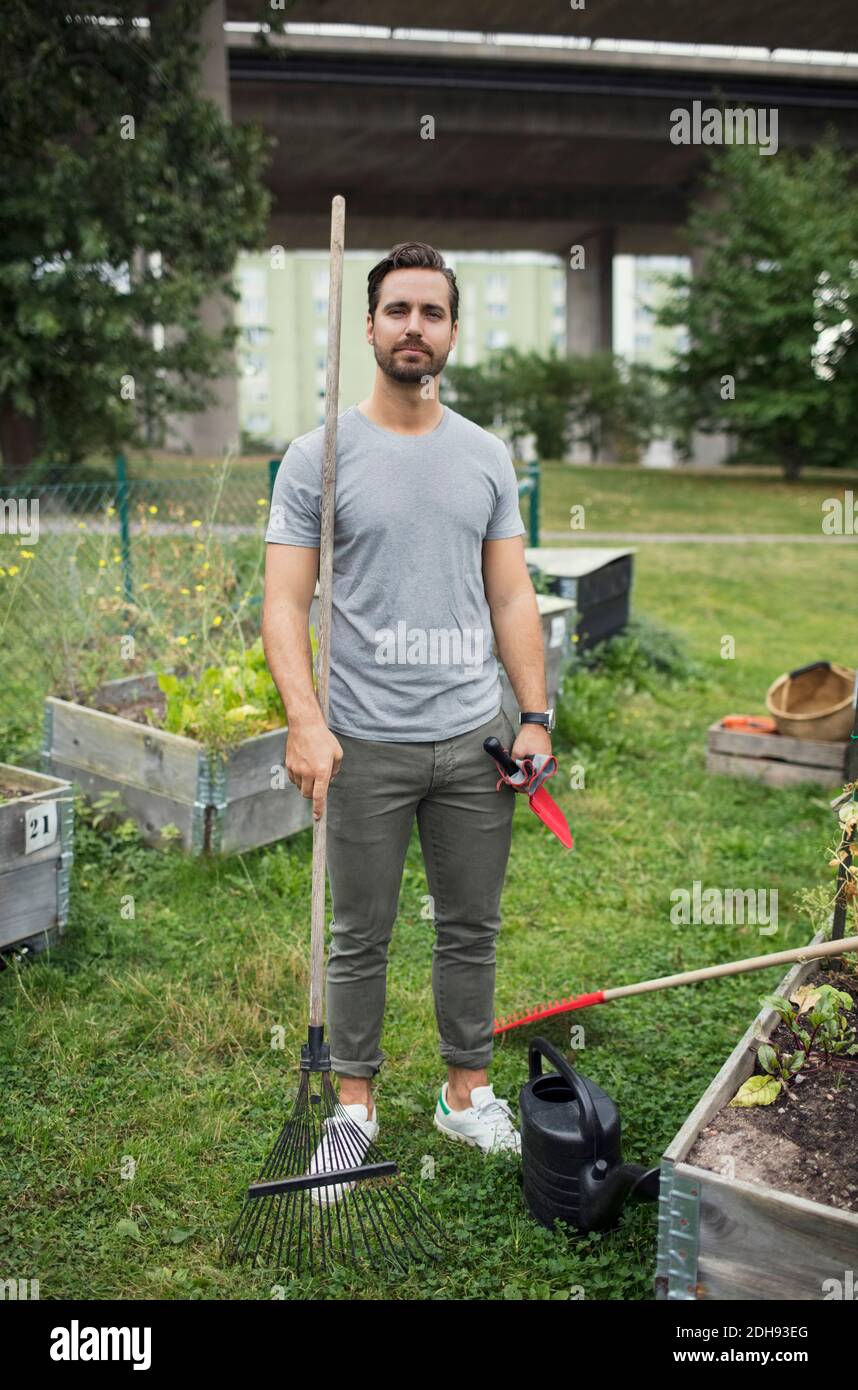 Man with rake hi-res stock photography and images - Alamy