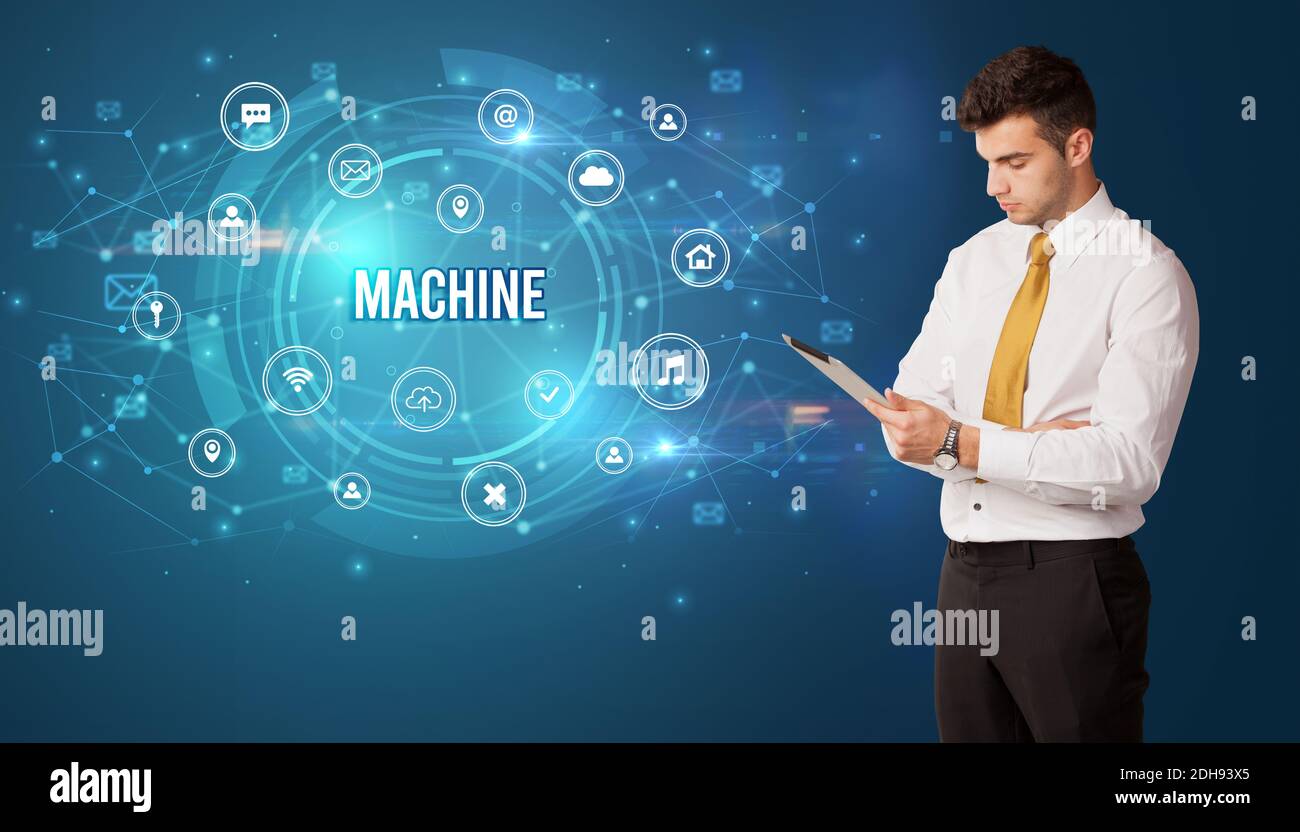 Businessman thinking in front of technology related icons and MACHINE ...