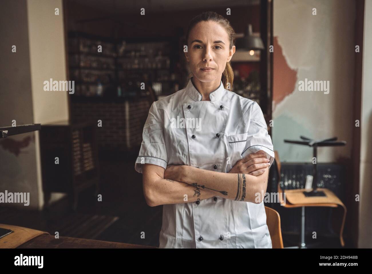 Portrait of chef with arms crossed standing in restaurant Stock Photo ...