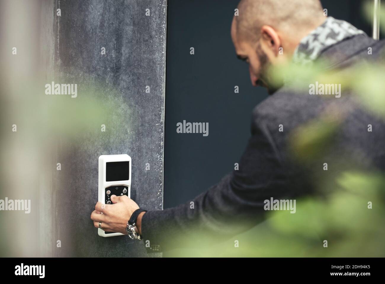Mid adult businessman entering keycode to open office door Stock Photo ...