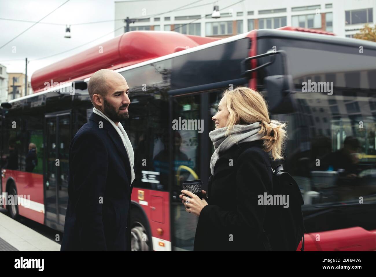 Business people talking on sidewalk by bus in city Stock Photo - Alamy