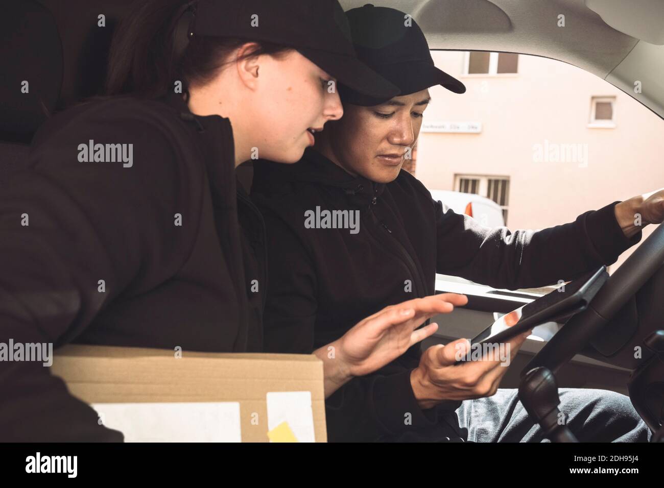 Male and female drivers using digital tablet in truck Stock Photo - Alamy