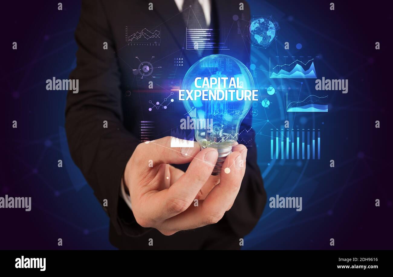 Businessman holding lightbulb with CAPITAL EXPENDITURE inscription, Business idea concept Stock ...