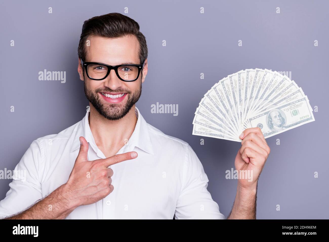 Portrait of positive man manager ceo investor hold money fan point ...