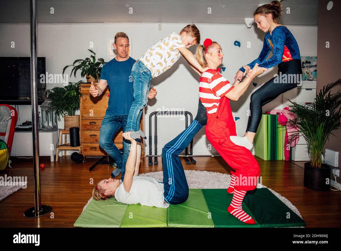 Family practicing balance exercise at home Stock Photo - Alamy
