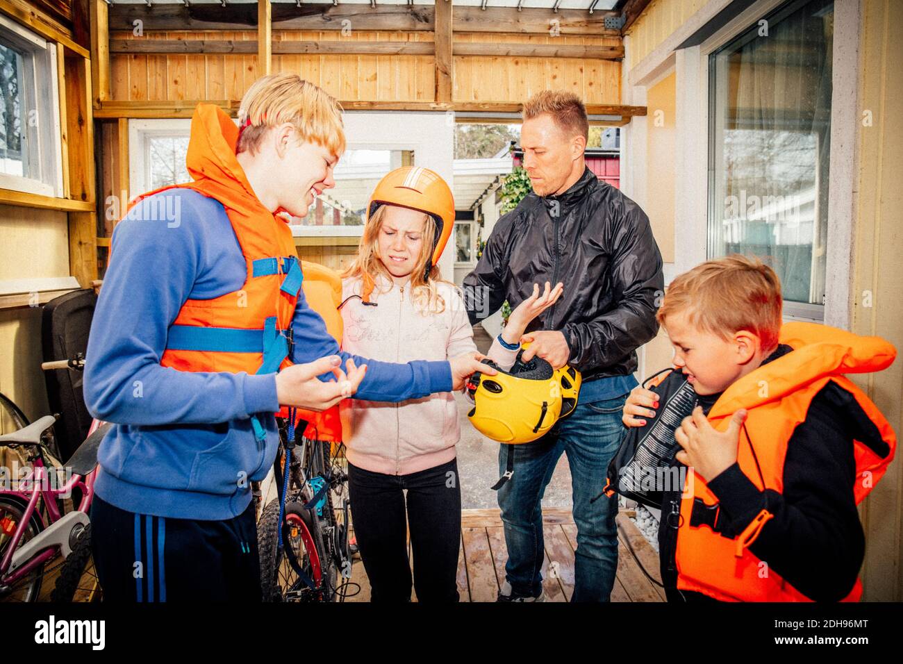 Father with children standing in garage Stock Photo - Alamy
