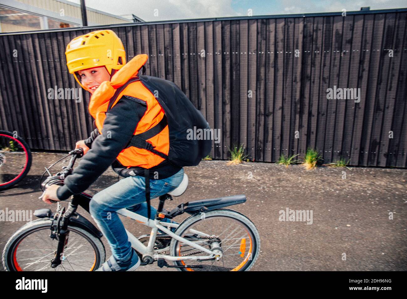 Portrait of smiling boy riding bicycle on road Stock Photo - Alamy