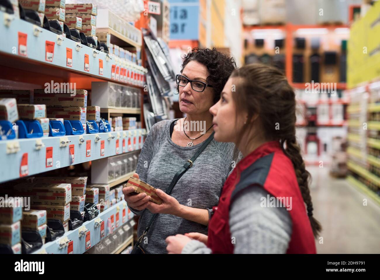 Saleswoman assisting female customer in hardware store Stock Photo - Alamy