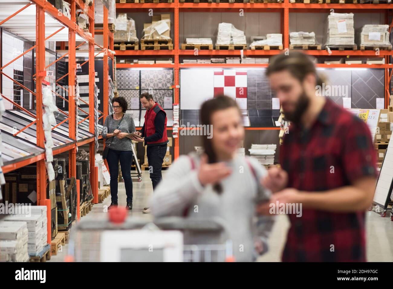 Salesman assisting female customer in hardware store Stock Photo - Alamy