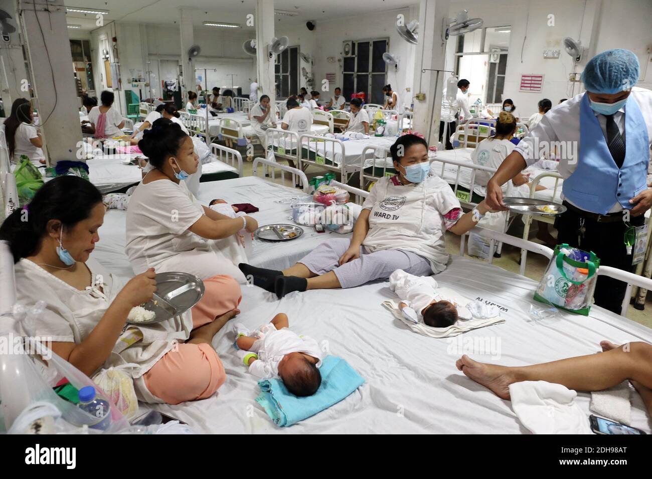 Manila, Philippines. 08th Dec, 2020. Mothers sit on the bed next to ...