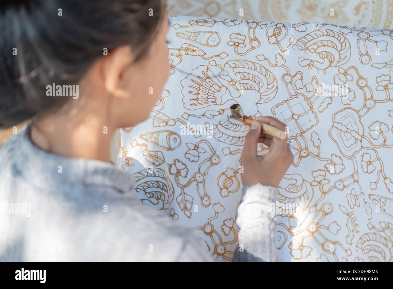 portrait young woman drawing batik on a white cloth using canting Stock ...
