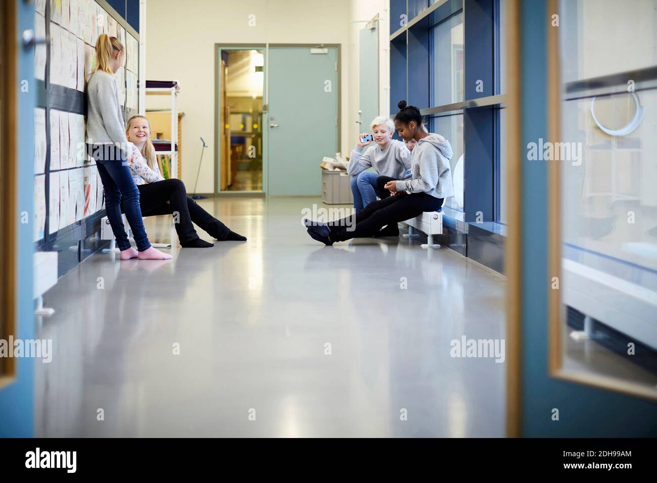 Junior high students in school corridor Stock Photo - Alamy