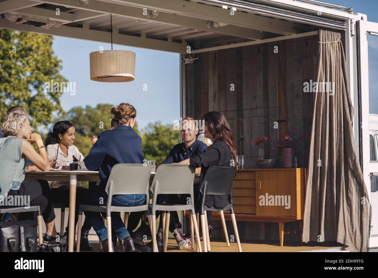 Business people working at desk in portable office truck Stock Photo ...