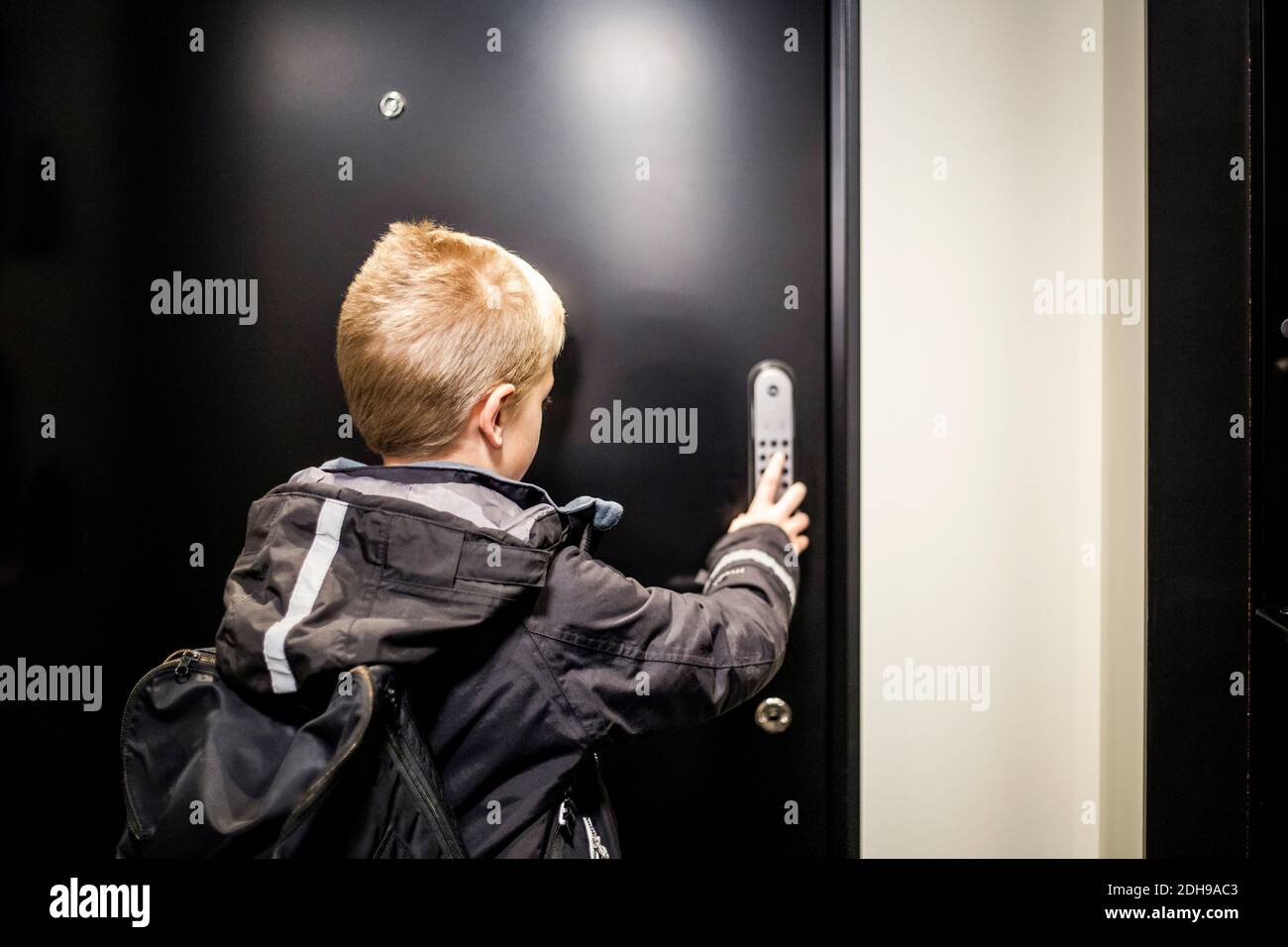 Boy unlocking door hi-res stock photography and images - Alamy