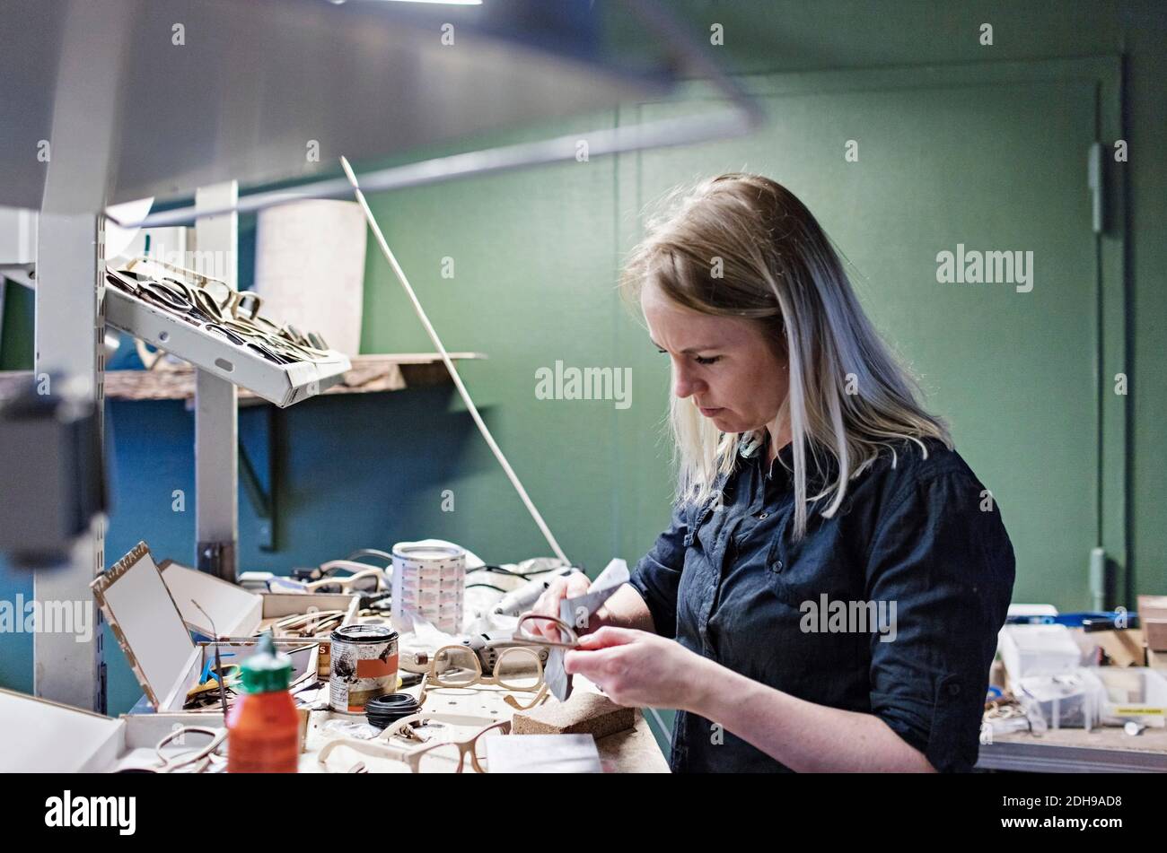 Female owner making eyeglasses in workshop Stock Photo - Alamy
