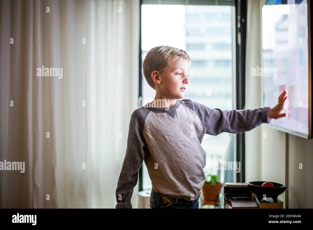 Boy touching tv screen hi-res stock photography and images - Alamy