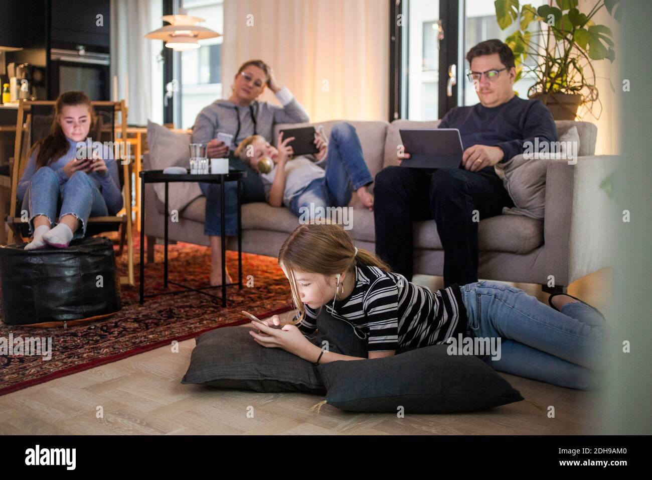 Family is using technologies in living room at modern home Stock Photo ...