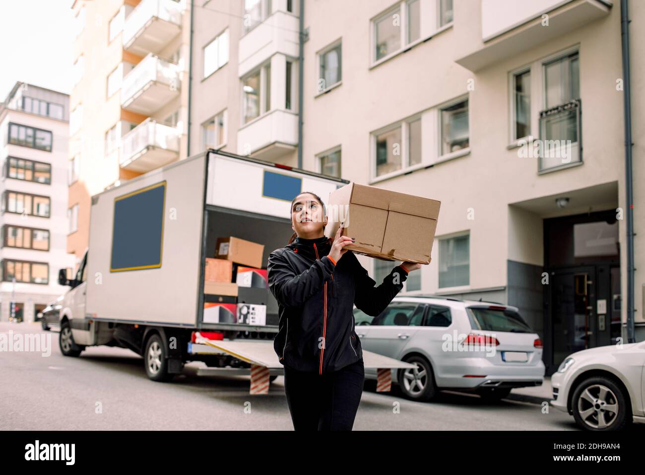 Woman moving box street hi-res stock photography and images - Alamy