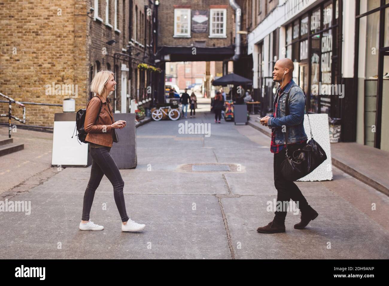 Two people walking towards each other hi-res stock photography and ...
