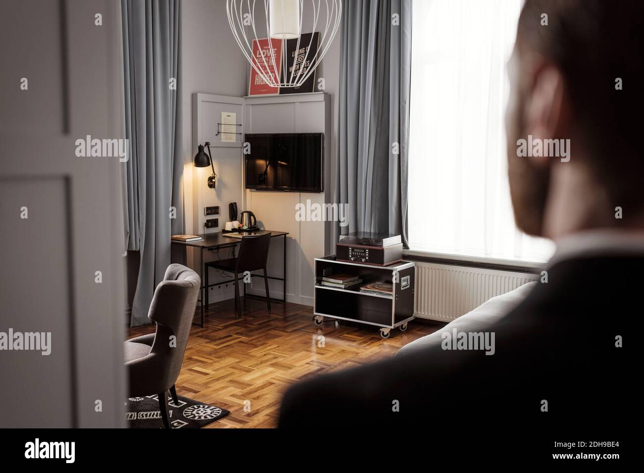 Rear view of businessman standing in hotel room Stock Photo - Alamy