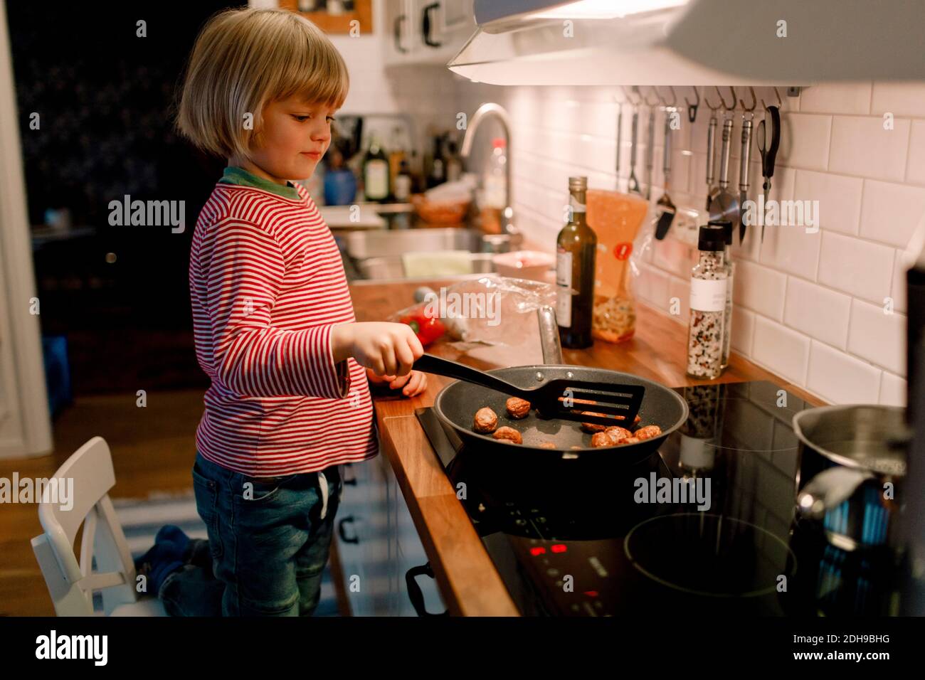 Side view of cooking food in kitchen at home Stock Photo - Alamy