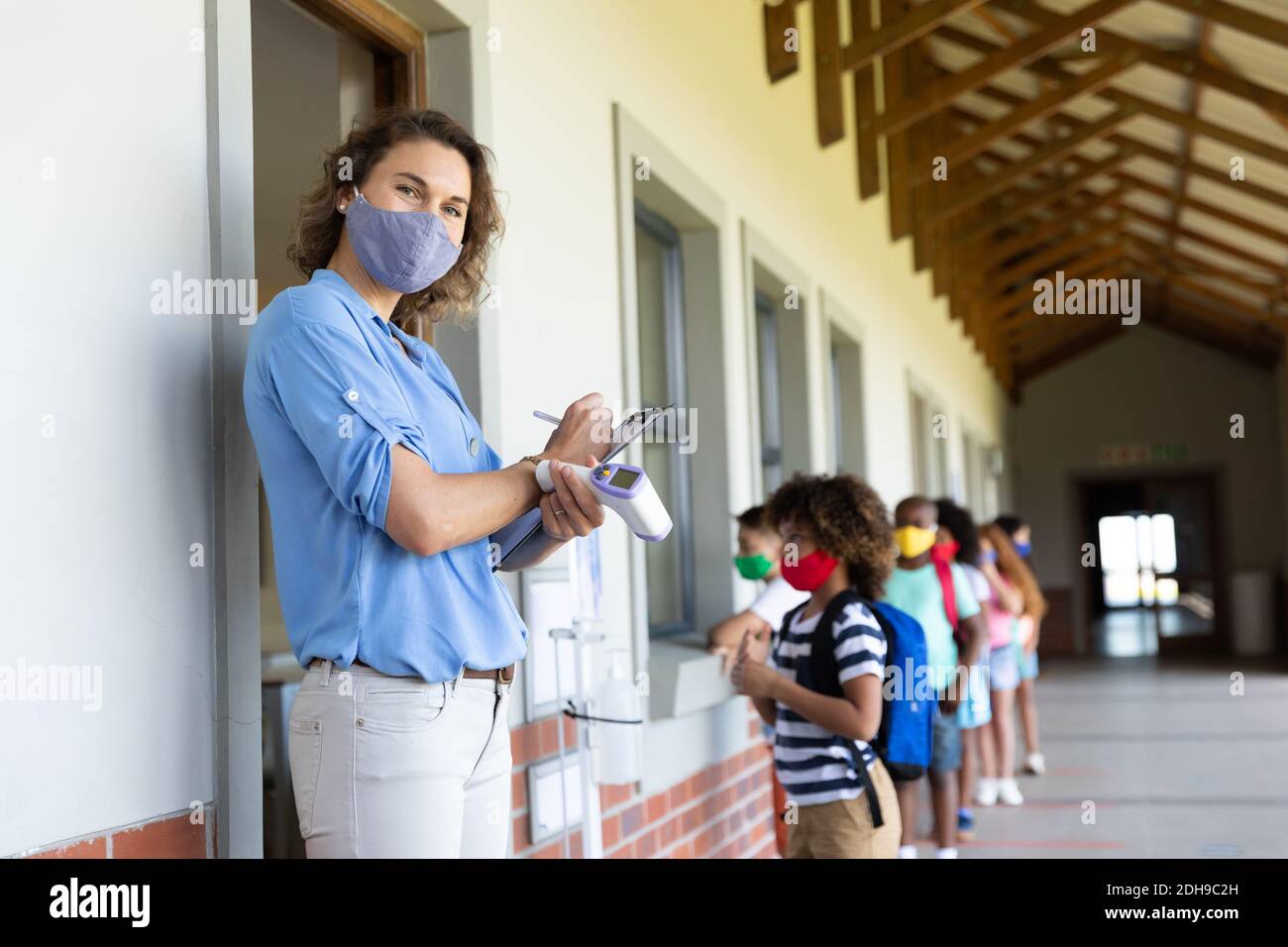 Female teacher wearing face mask hi-res stock photography and images ...