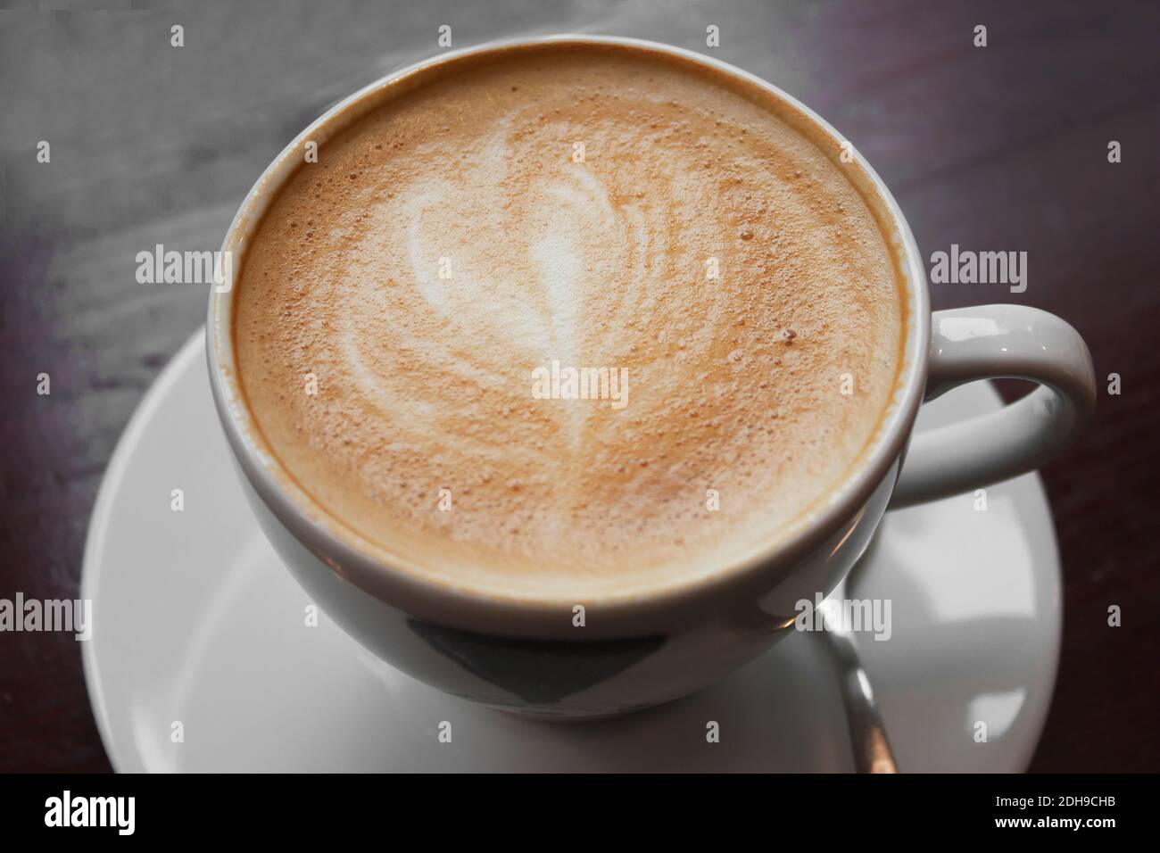 Cup of coffee with froth in a white mug on the table, in a cafe Stock ...