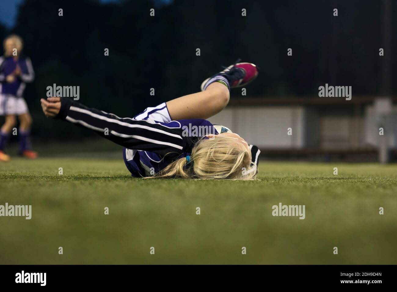 Surface level view of fallen athlete on soccer field Stock Photo - Alamy