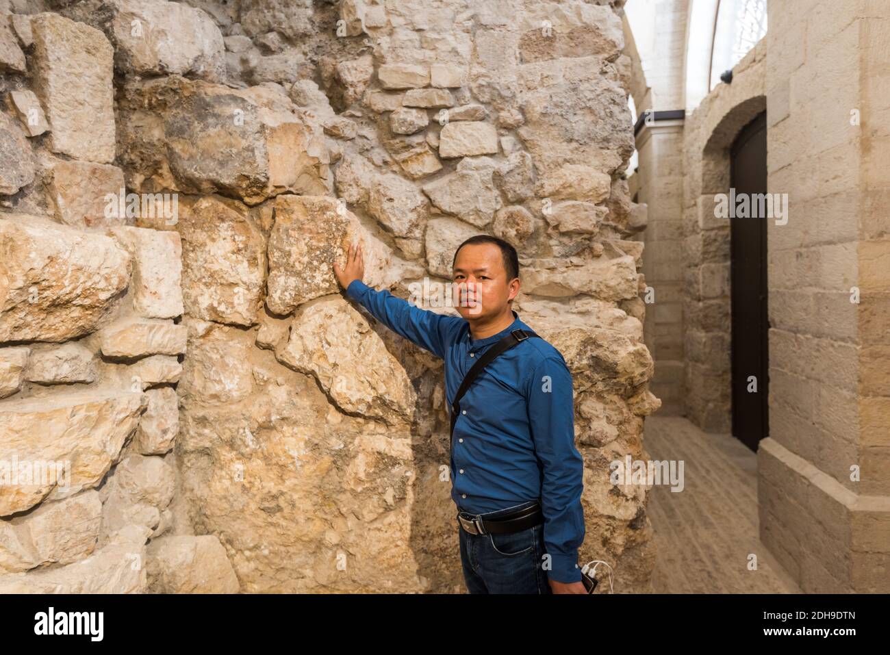 A Chinese tourist with Historical relics of stone wall in Terra Sancta ...