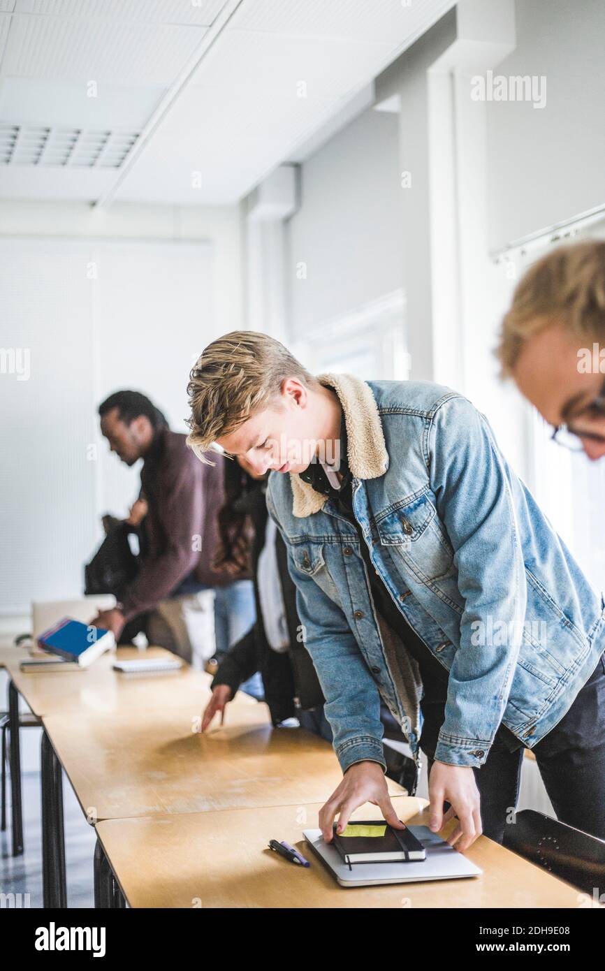 Young man in university classroom Stock Photo - Alamy
