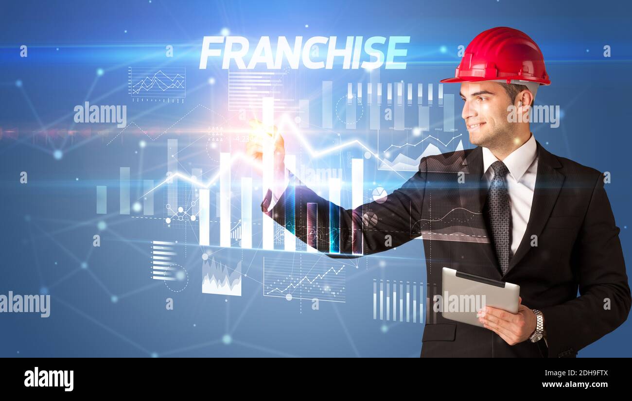 Handsome businessman with helmet drawing FRANCHISE inscription ...