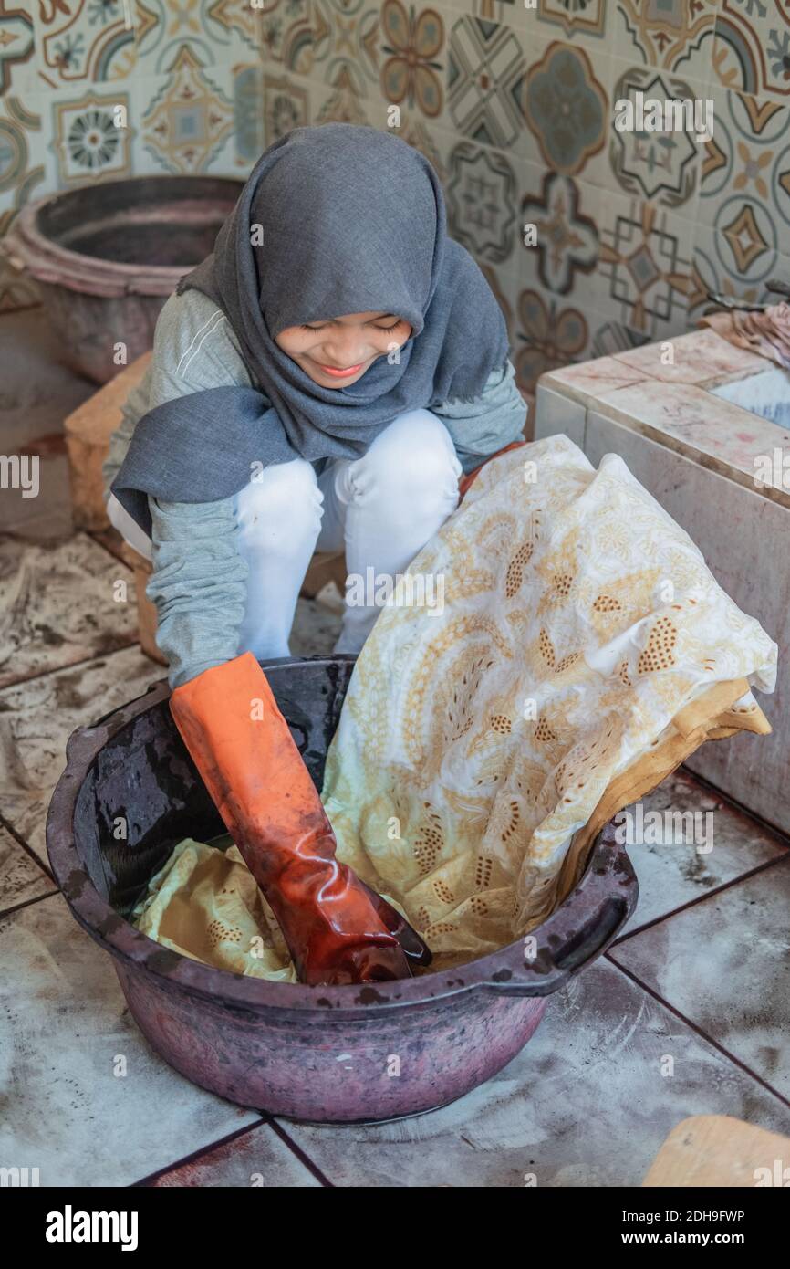 a portrait of a woman giving the water color to the batik cloth Stock ...