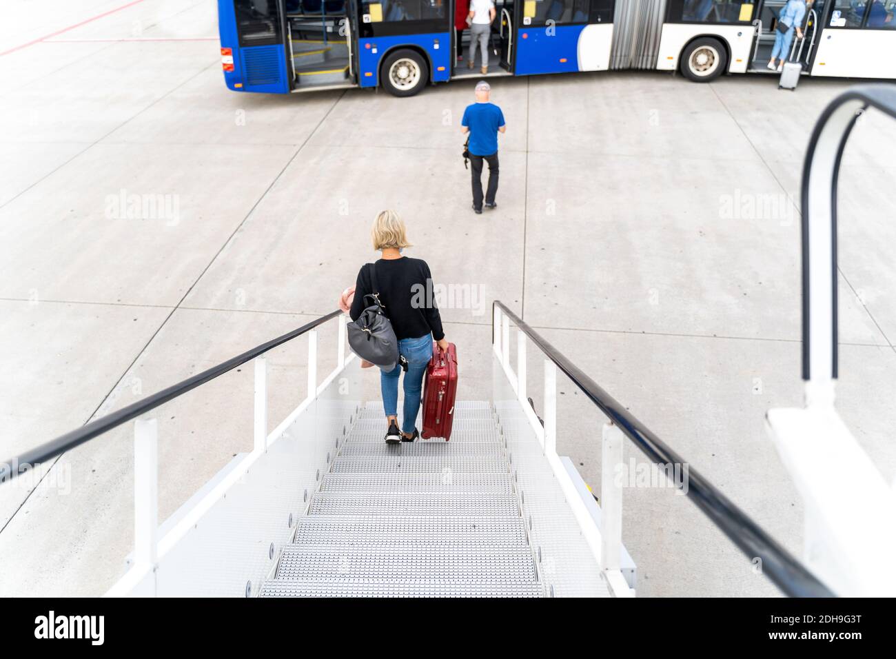 Passengers at the airport with laggage getting off a plane Stock Photo ...