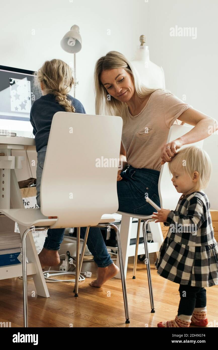 Female design professional with daughters at home Stock Photo - Alamy