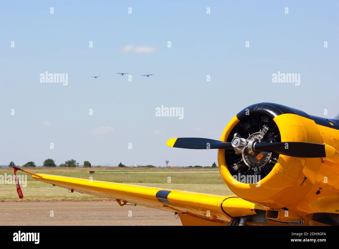 Yellow Aerobatic Aircraft With Formation On Approach Stock Photo - Alamy