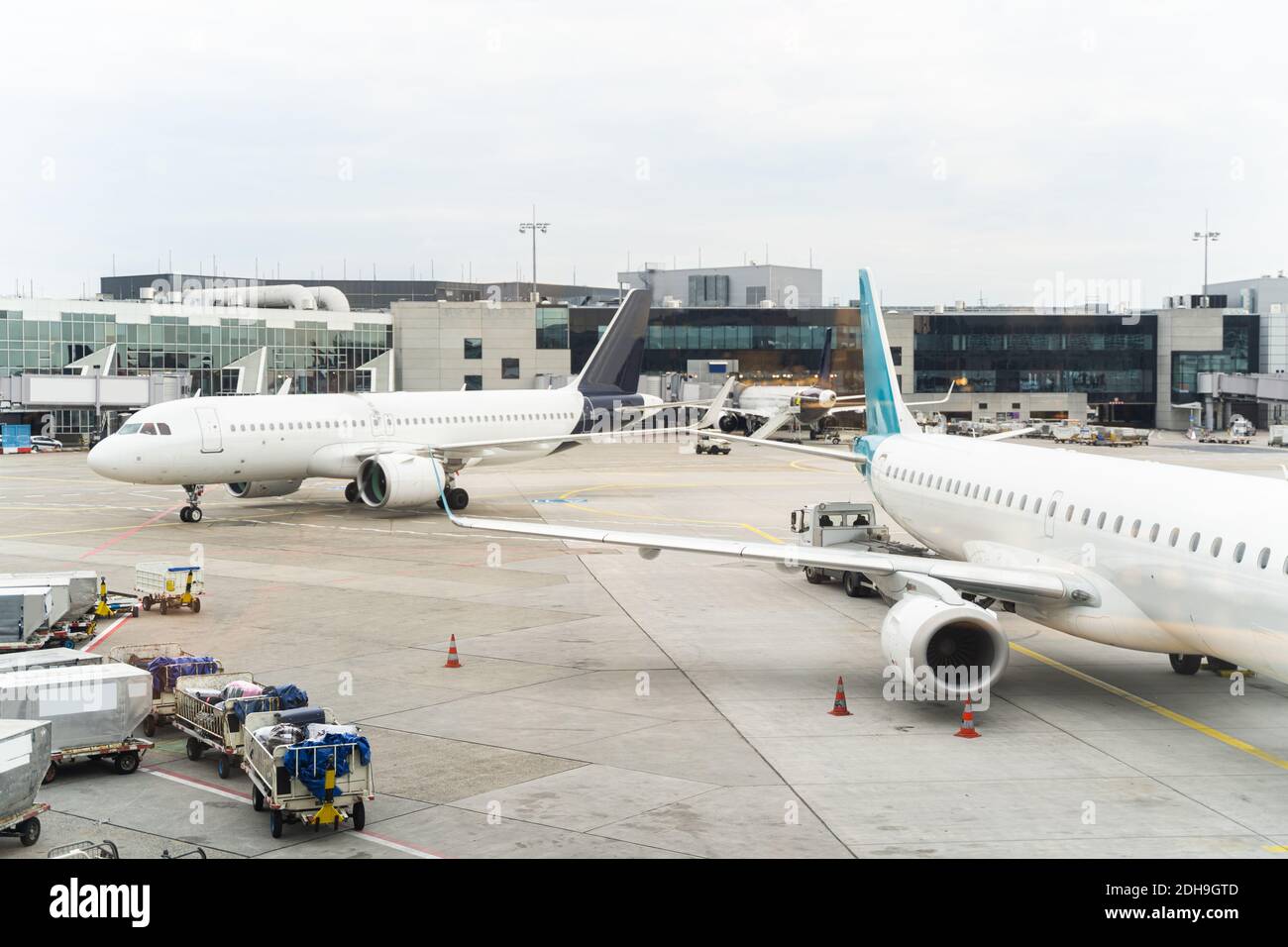 Low-cost airplanes queue for loading on airfield Stock Photo - Alamy