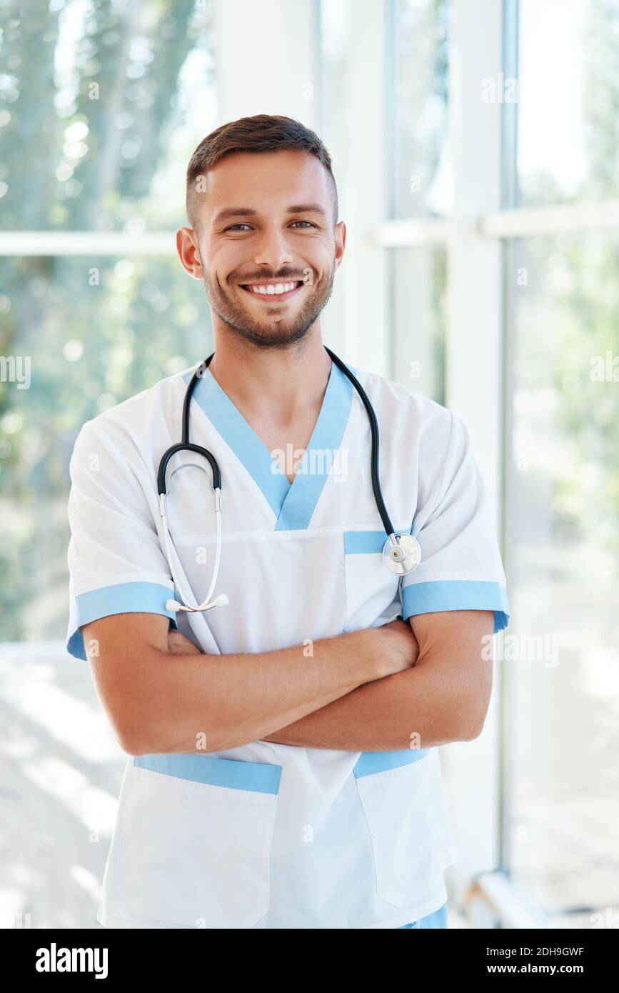 Portrait of confident smiling male doctor with stethoscope in medical ...