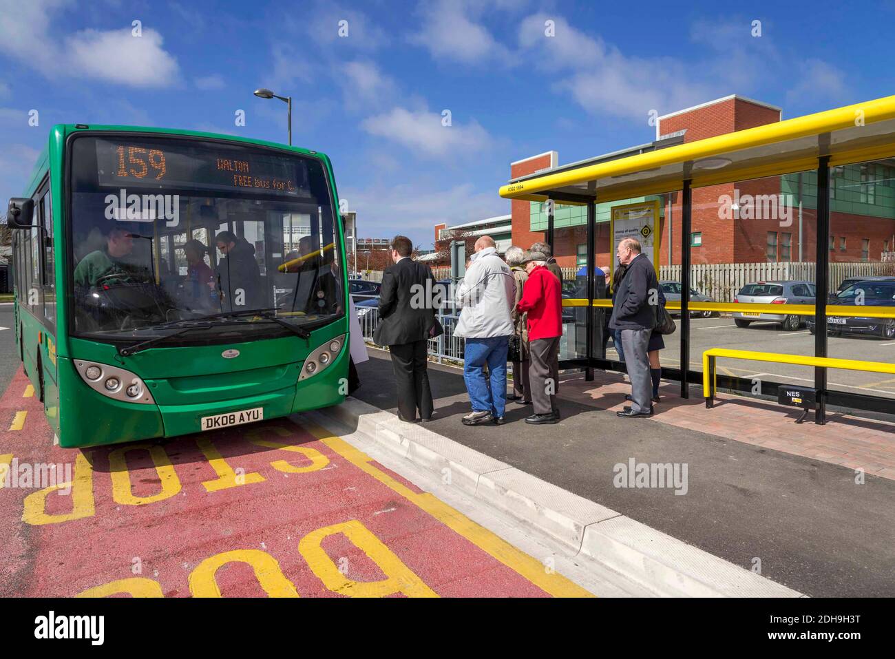 Bus at a bus shelter with a queue of passengers boarding Stock Photo ...