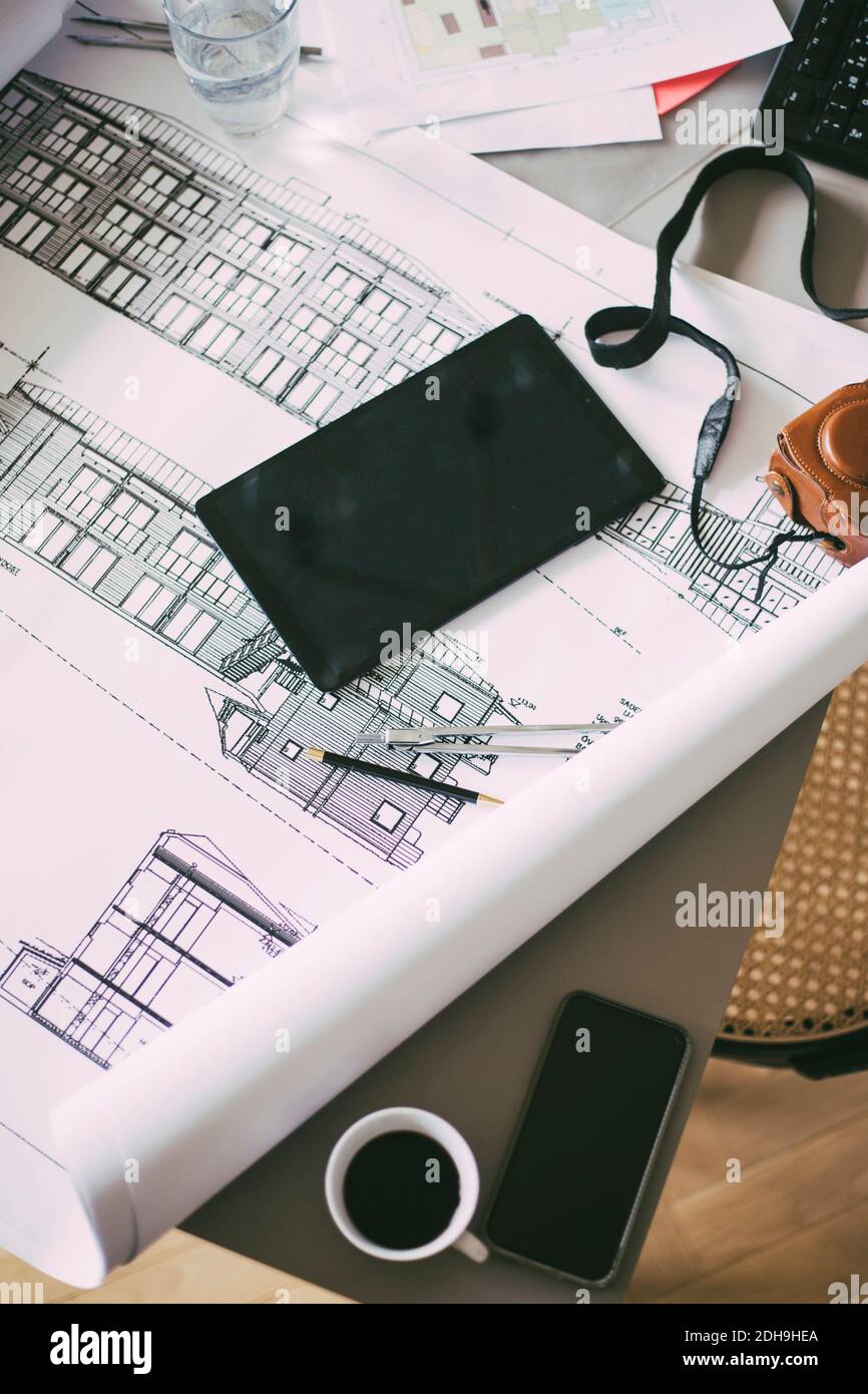 Detail of blueprint and digital tablet at home office Stock Photo - Alamy
