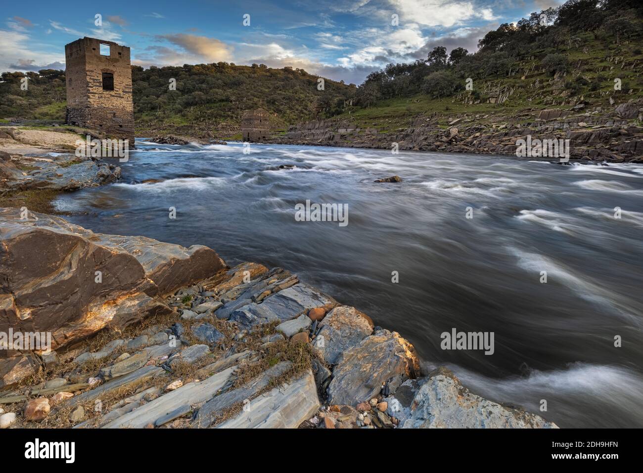 A beautiful sunset landscape over an ancient tower on the bank of the ...